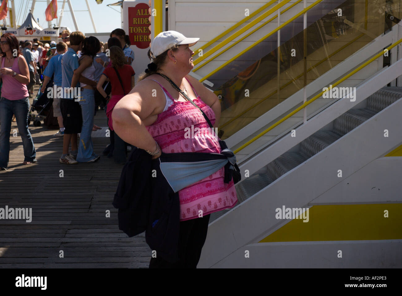 An overweight woman standing with hands on hips Stock Photo - Alamy