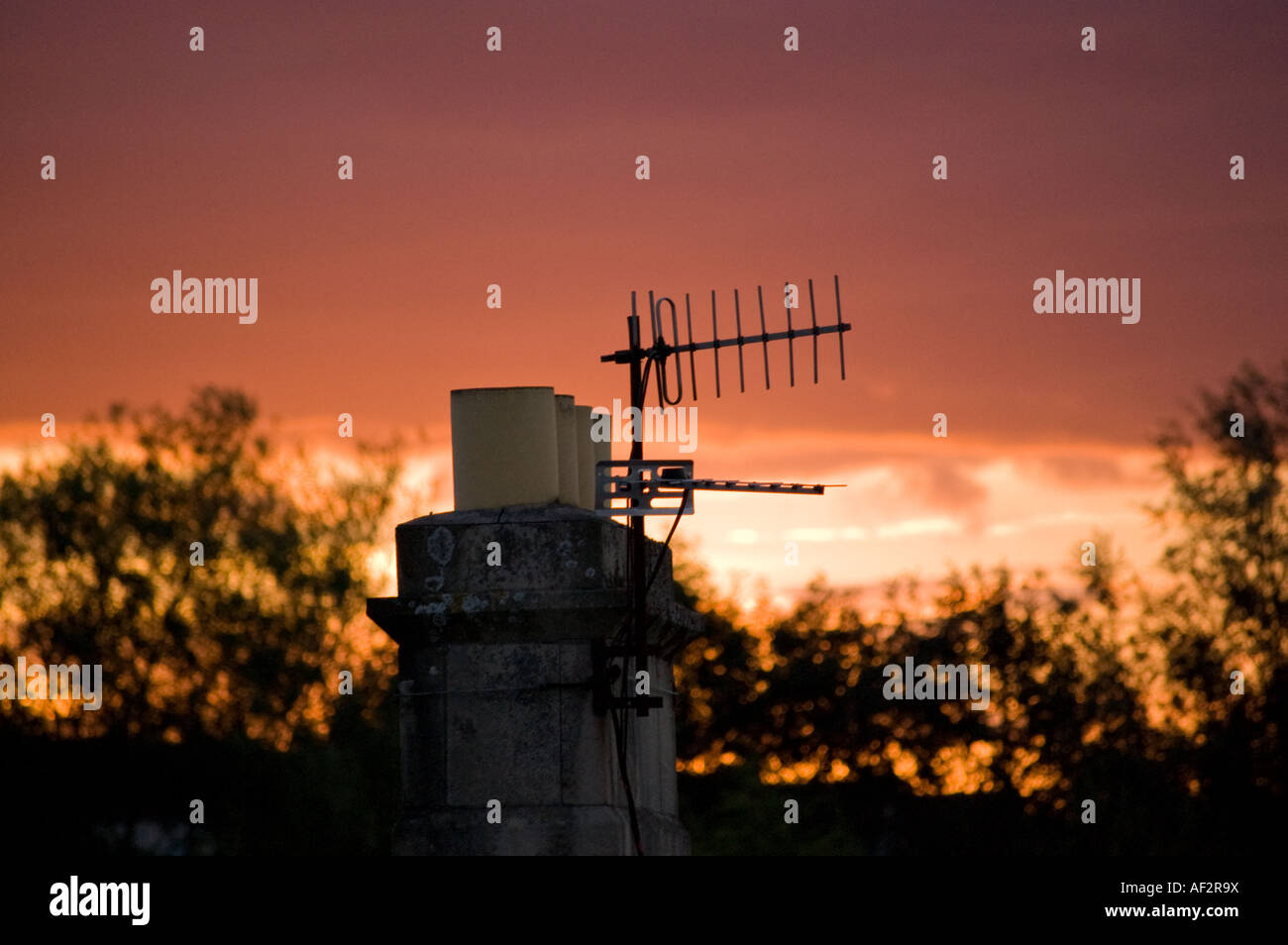 Orange and red sunset making the most of an ordinary brick chimney ...