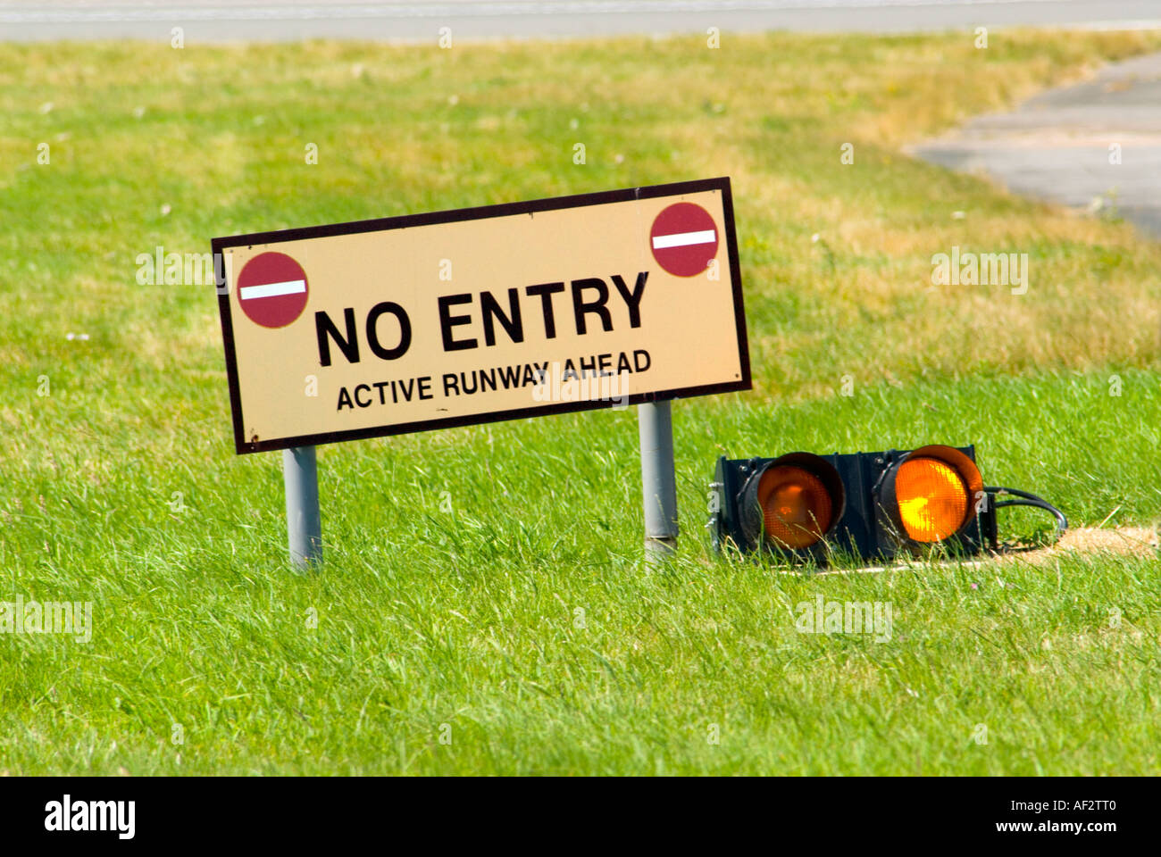 A NO ENTRY sign and flashing warning lights on a taxyway protects the ...
