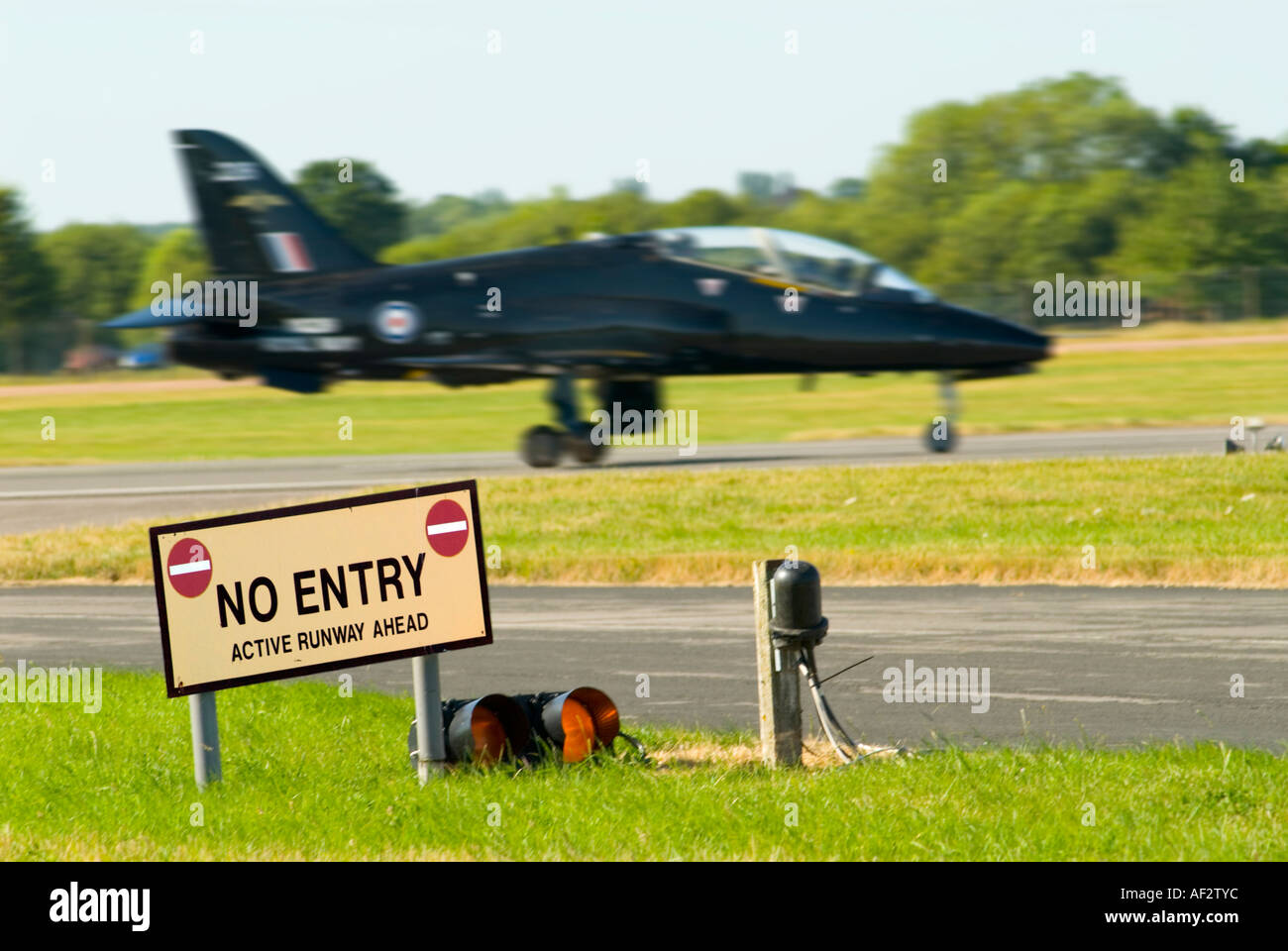 A NO ENTRY sign and flashing warning lights on a taxyway protects the ...