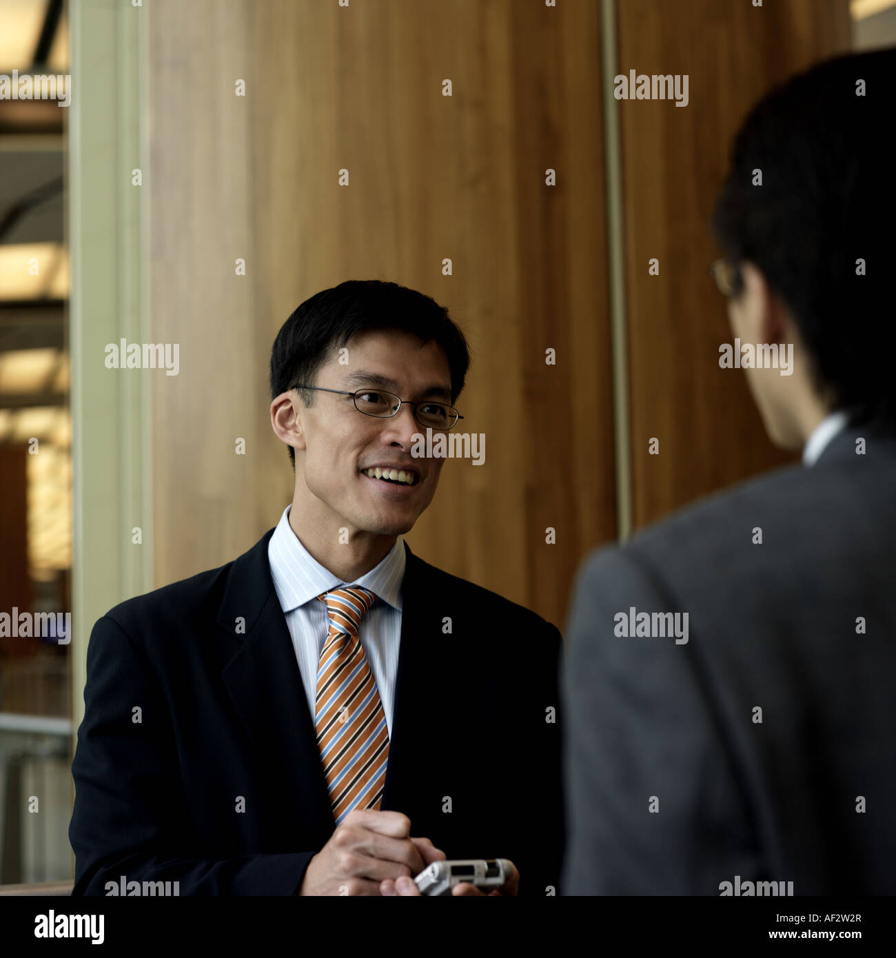 Over shoulder two businessmen talking hi-res stock photography and ...