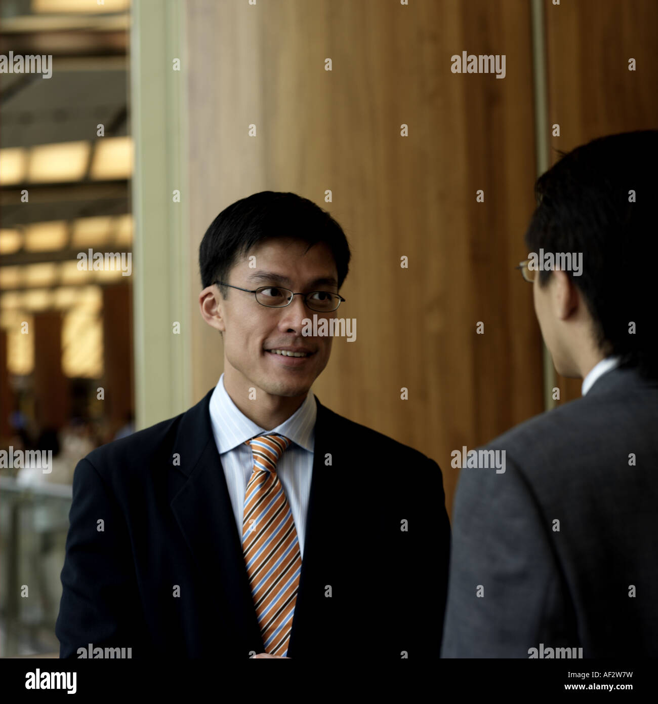 Businessmen talking, over the shoulder view Stock Photo - Alamy