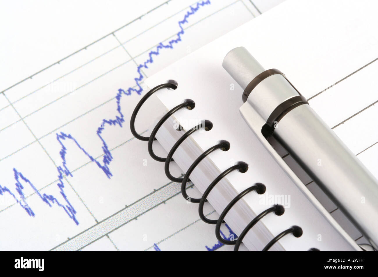 pen and notebook on stock chart Stock Photo - Alamy