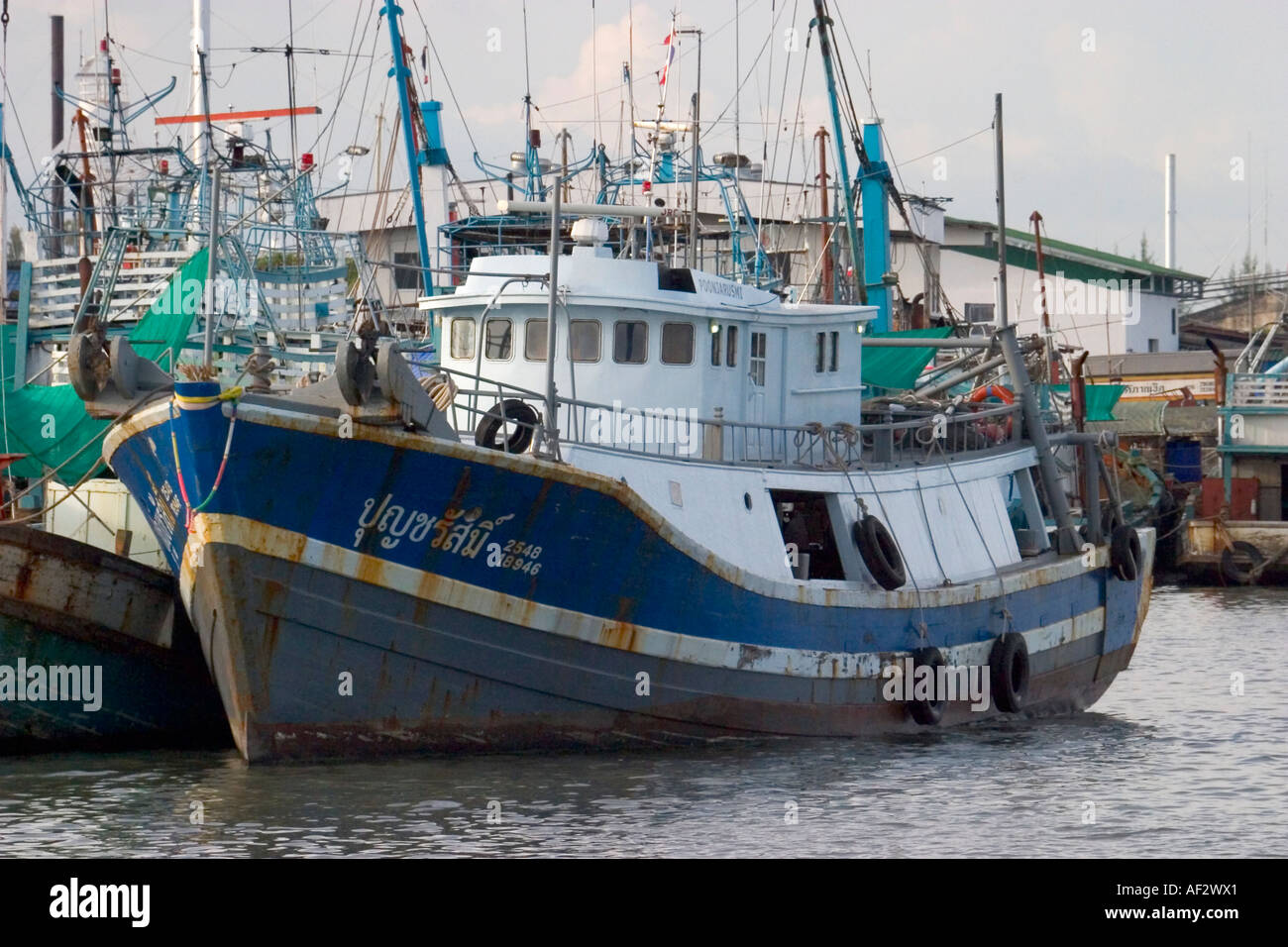 Thai fishing boats tied up at Phuket port docks harbour thailand flag stereotypical Phang Nga ...