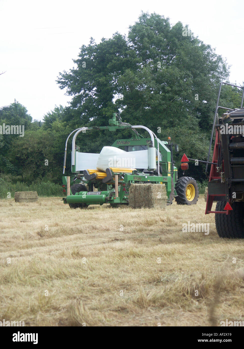 Hay making and baling British Countryside Bales. Wrapping bales in the ...