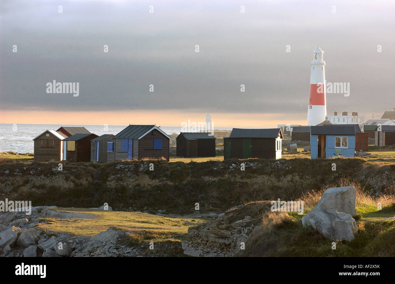 Beach huts and the lighthouse built in 1905 at Portland Bill Dorset ...
