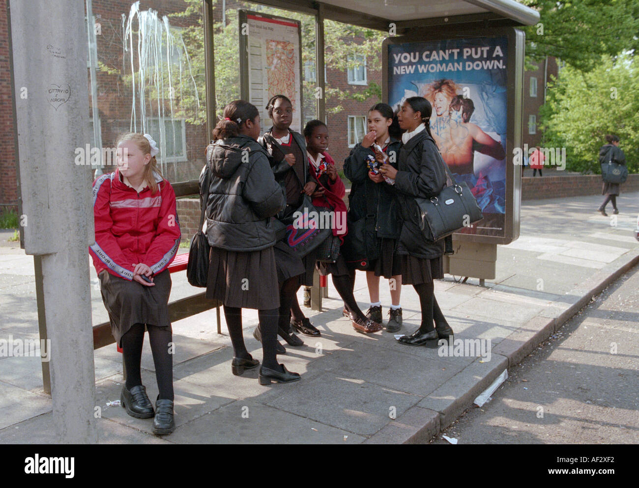 Group of secondary school children going home waiting at bus stop Stock ...