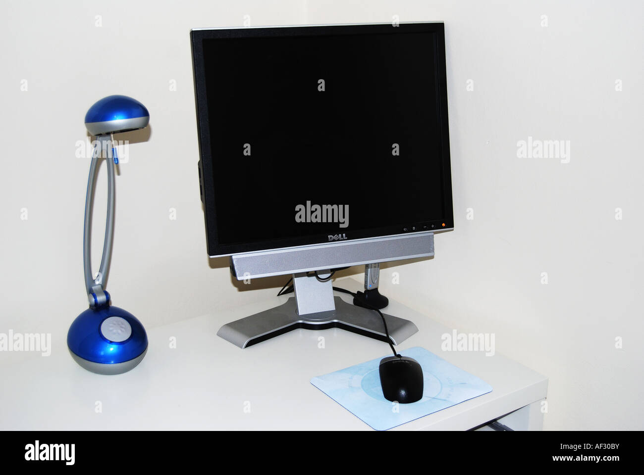 Modern flat-screen computer monitor with mouse and table lamp Stock ...