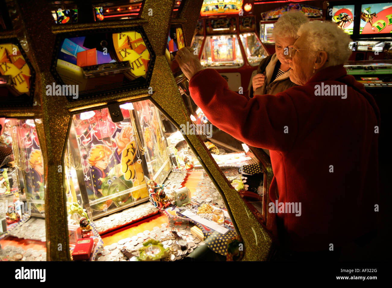 Ladies playing at an amusements arcade at Clacton pier, Clacton on Sea ...