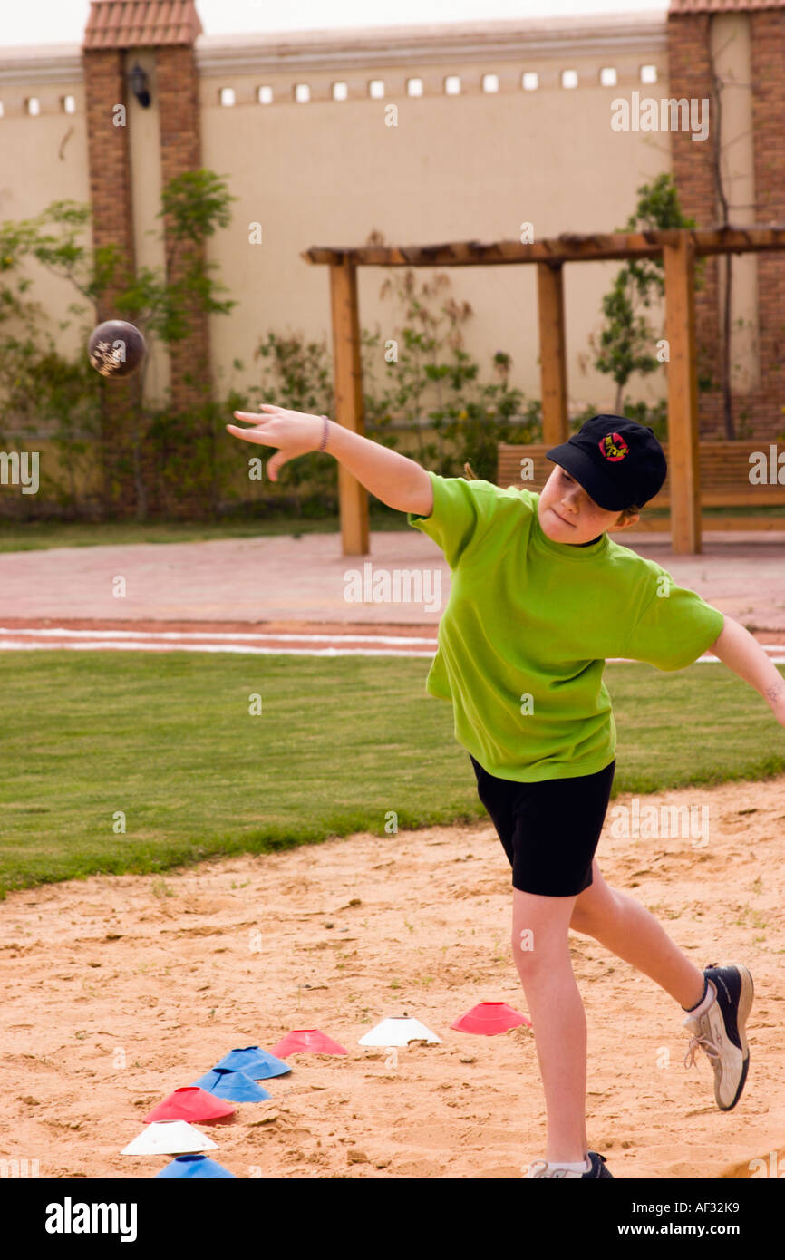 school girl throwing shot putt on school sports day Stock Photo - Alamy