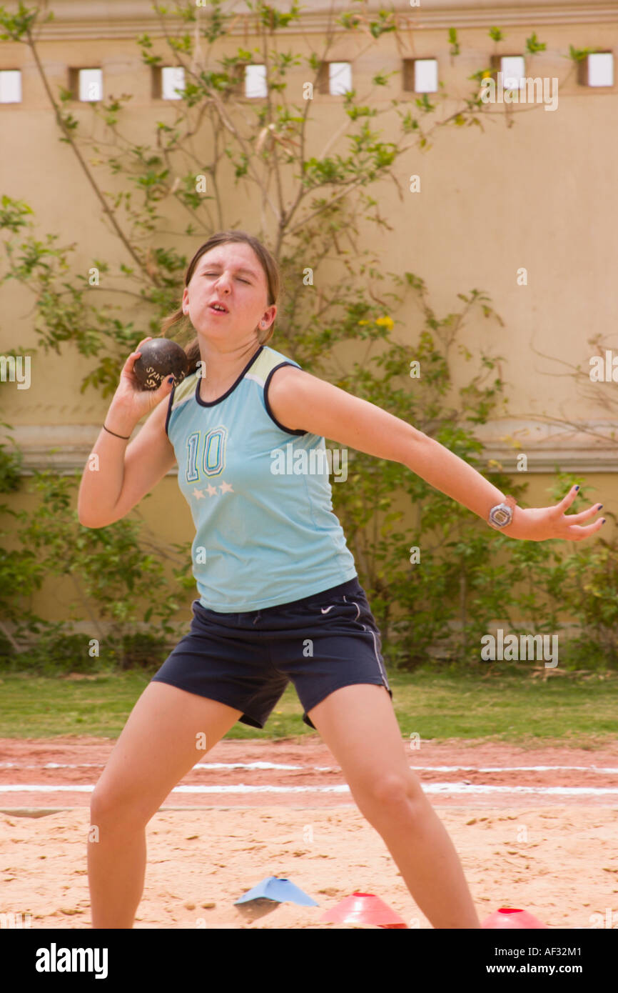 school girl throwing shot putt on school sports day Stock Photo - Alamy