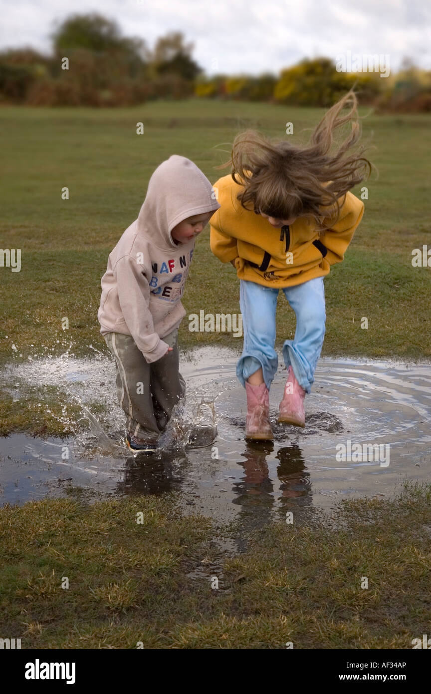 Little Boy Girl Jumping in a Big Puddle in Round Hill Camp Site New ...