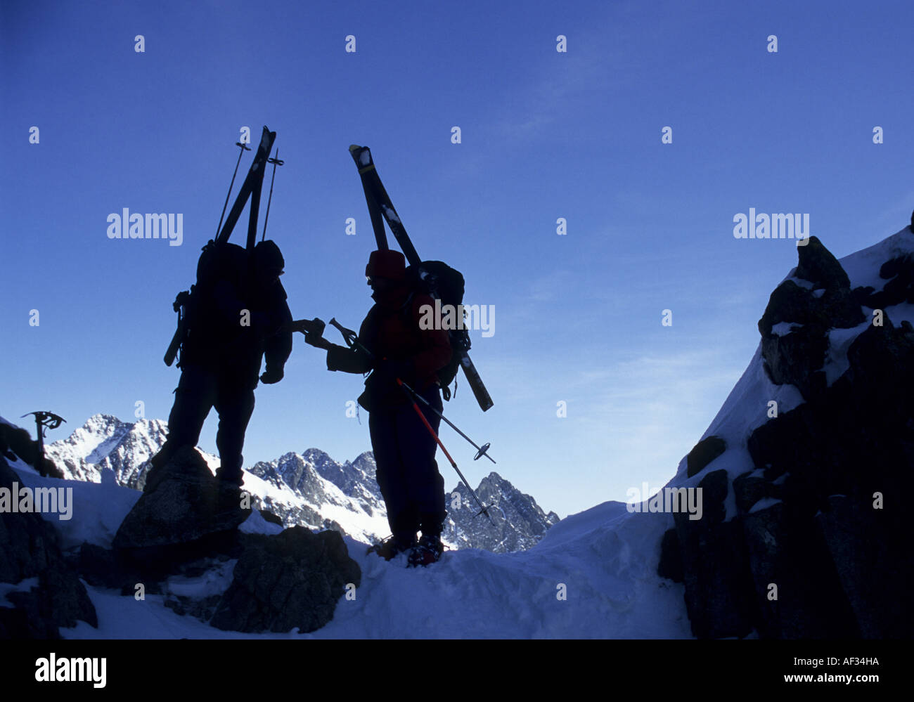 Silhouettes of two ski alpinists on top of the Sedlo Prielom, High ...