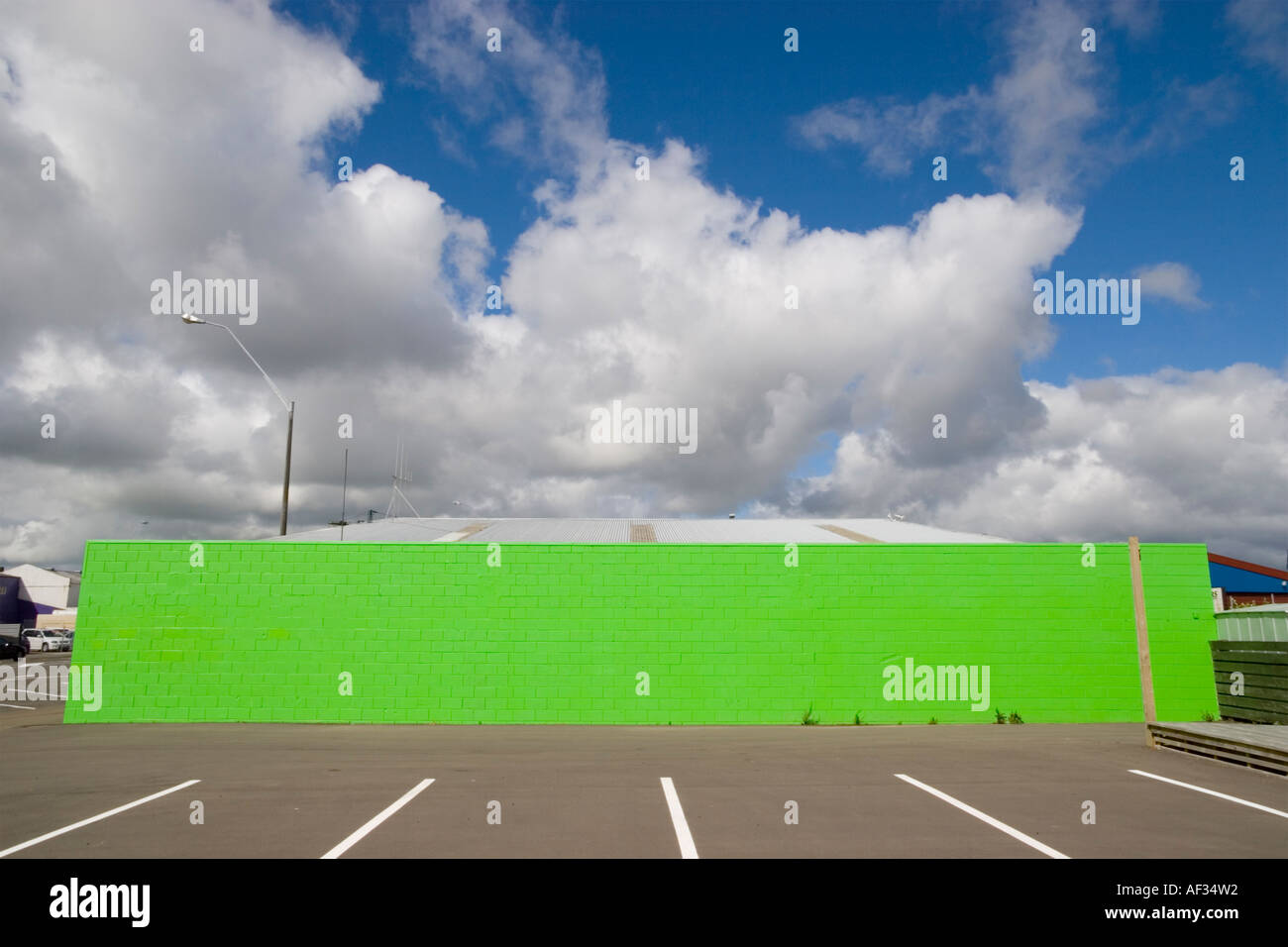 parking lot in front of green building Stock Photo - Alamy