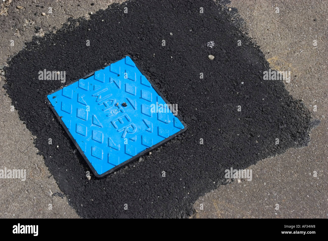 blue water main on street Stock Photo - Alamy