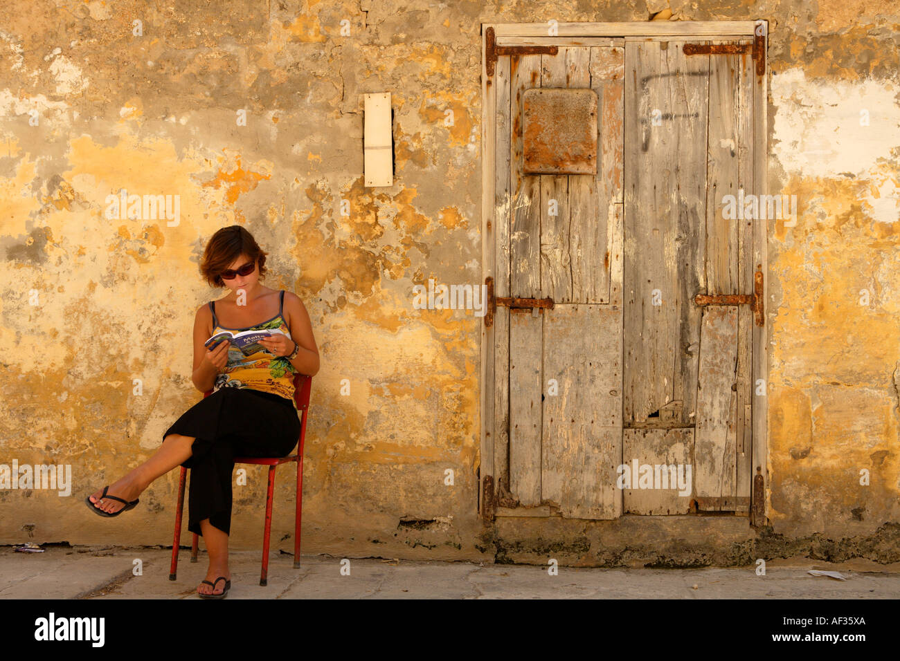 Tourist reading Travel Guide, Victoria, Gozo, Malta Stock Photo - Alamy
