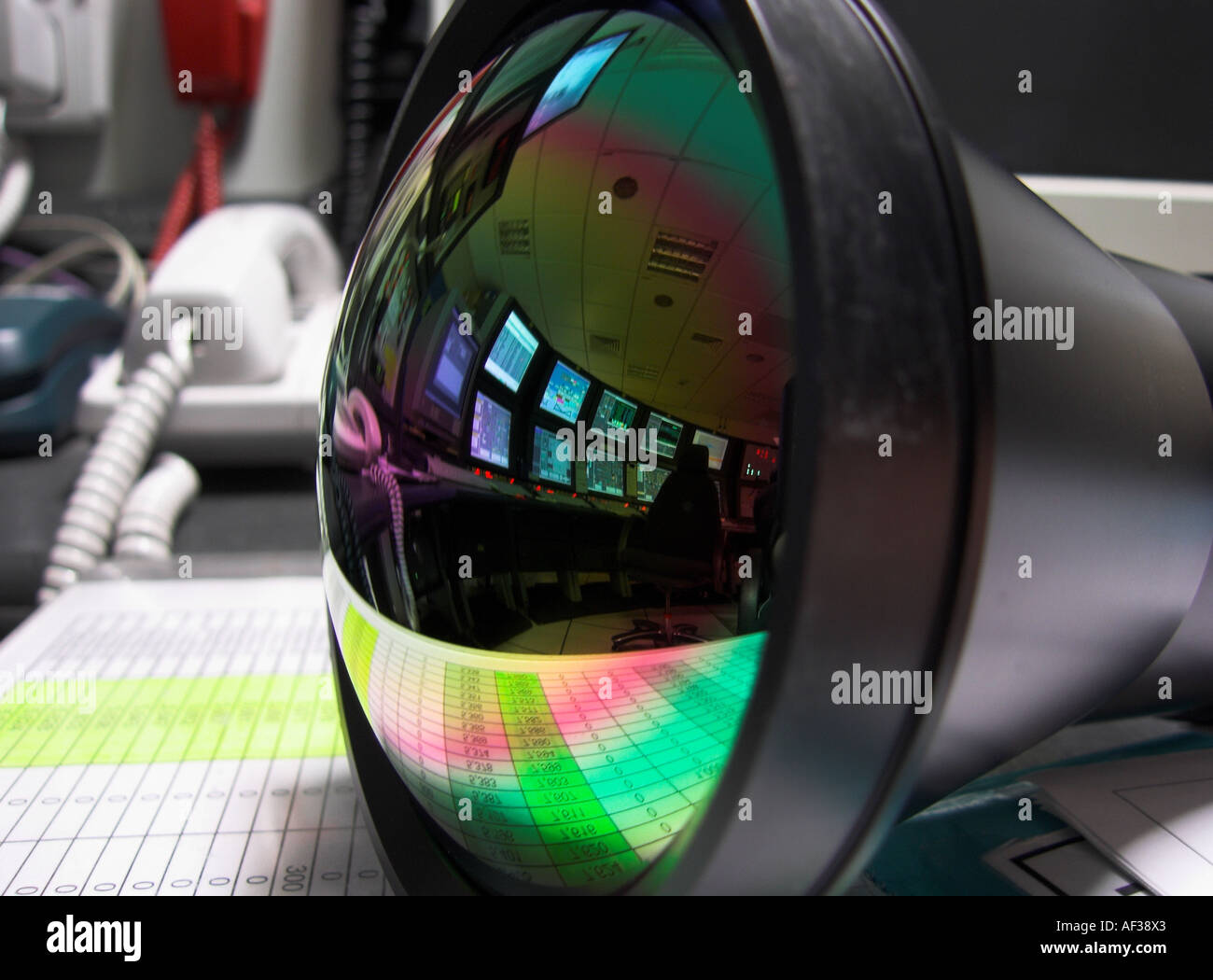 Abstract image of a multi coloured reflection in a lens of a control ...
