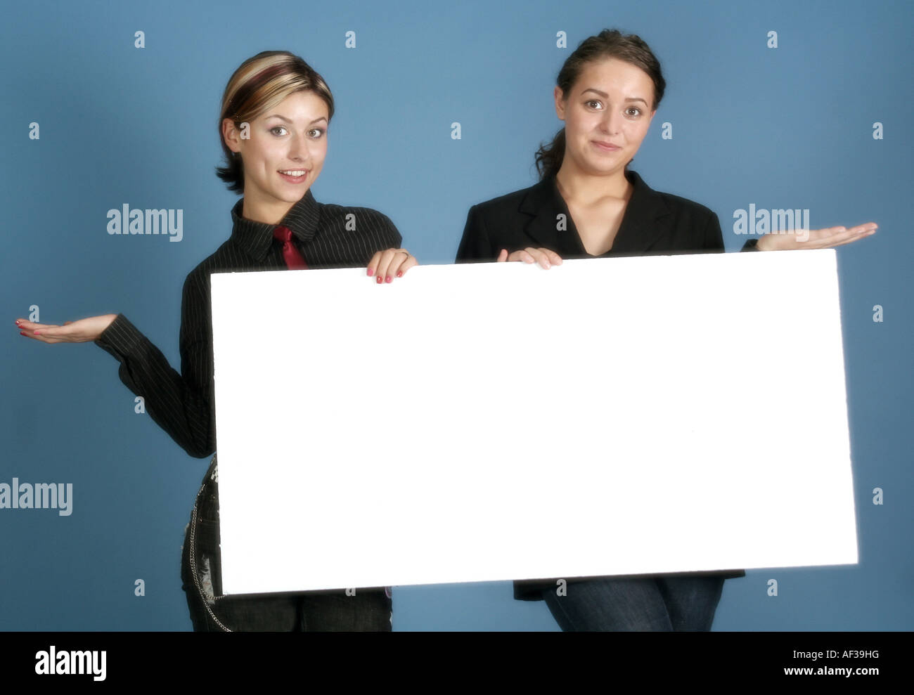 two ladies with a board Stock Photo - Alamy