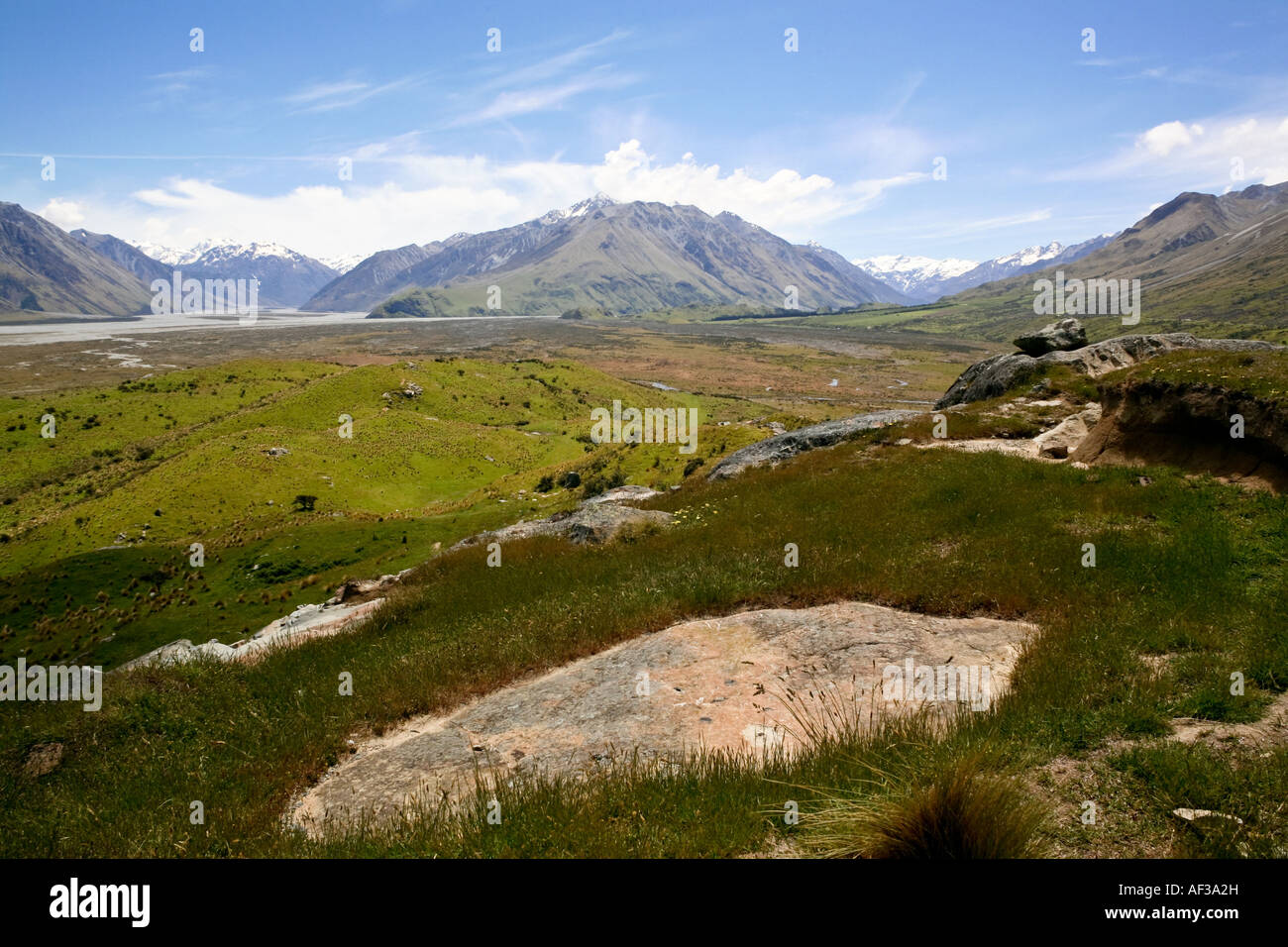Rocks and alpine grasses on Mount Sunday, looking towards Cloudy Peak ...