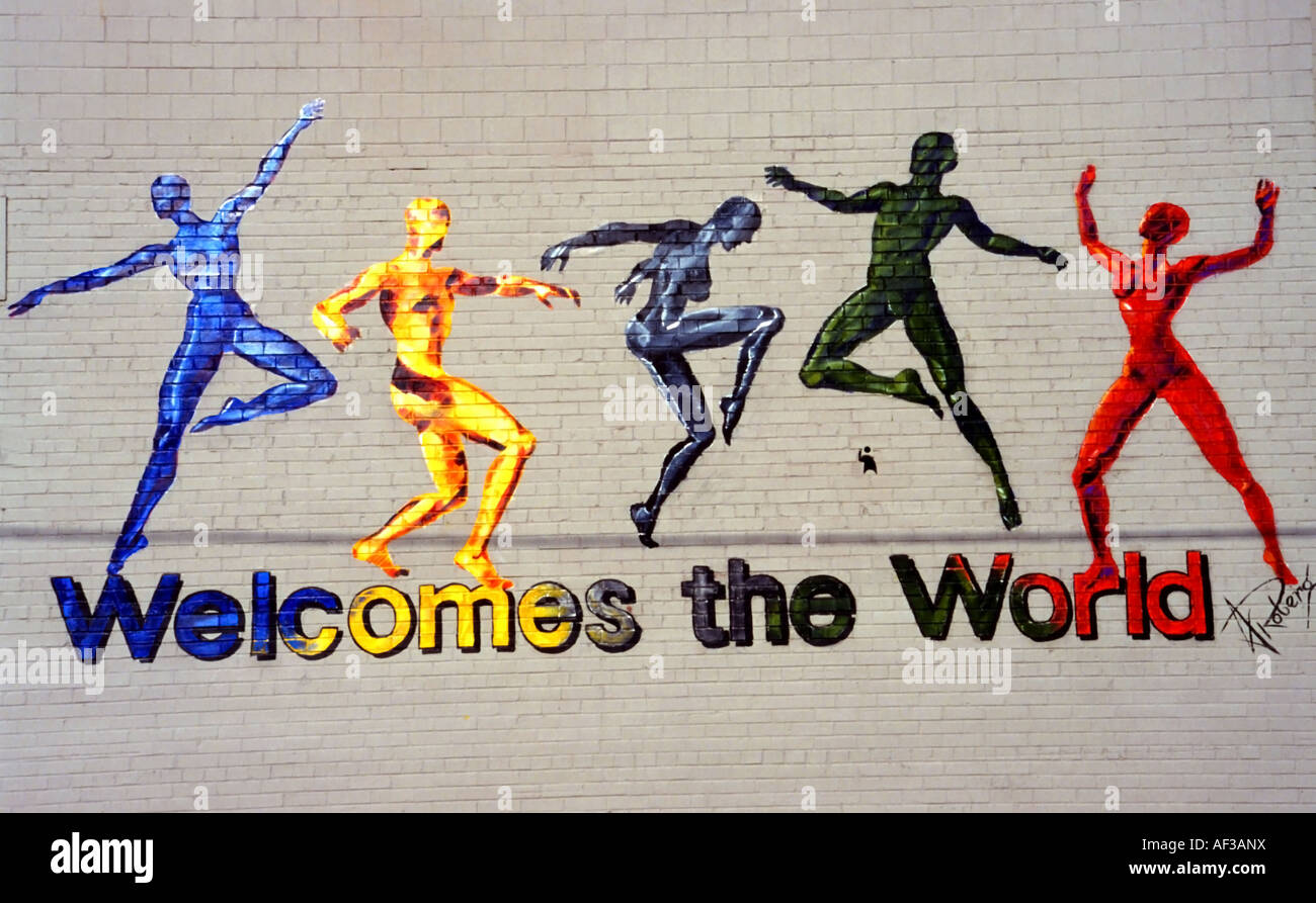 A colorful mural of silhouette ballet dancers adorn a drab brick wall ...