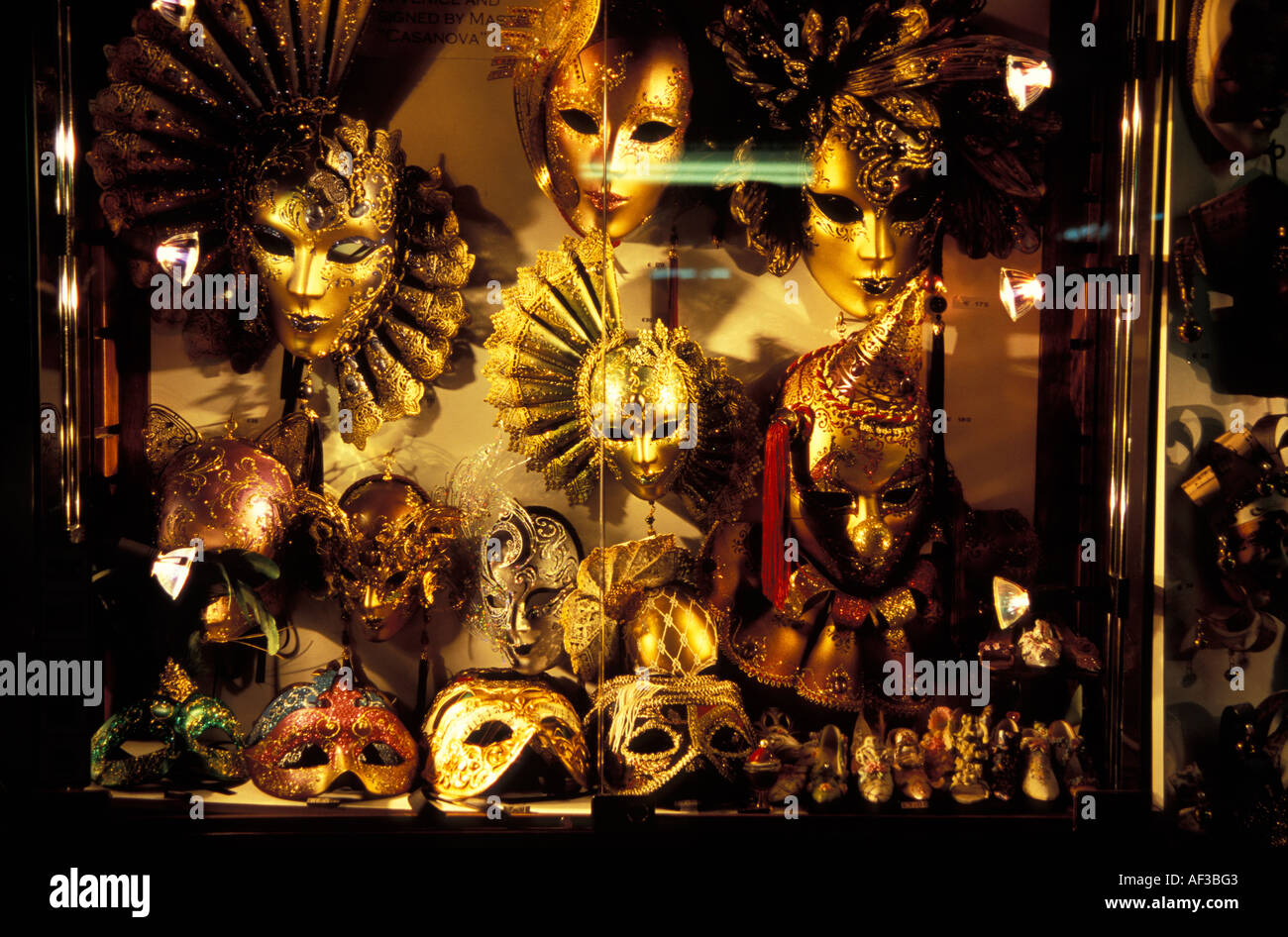Golden Venetian Carnival masks in display case, Venice, Italy Stock ...