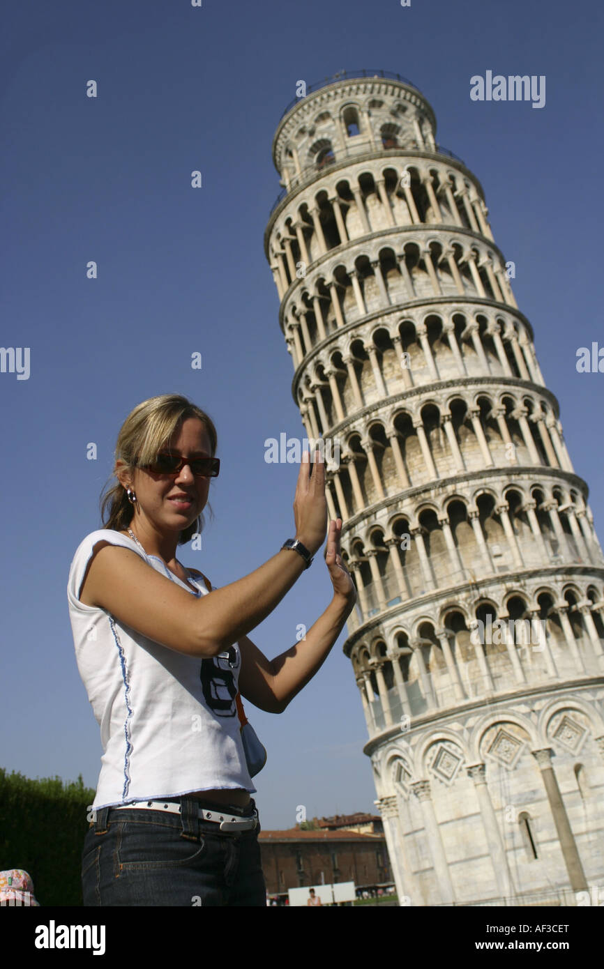 leaning tower of Pisa getting stilt by a young woman, Italy, Tuscany ...
