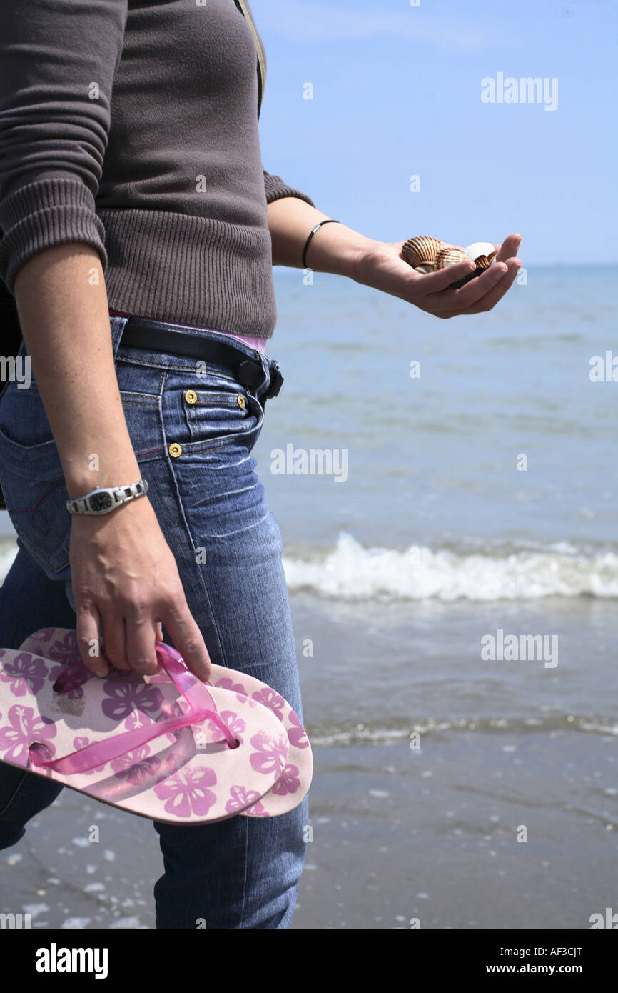 One woman collecting on the beach hi-res stock photography and images ...