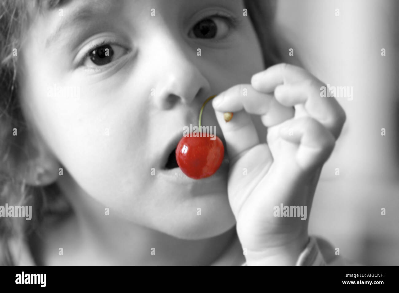 child eating a cherry Stock Photo - Alamy