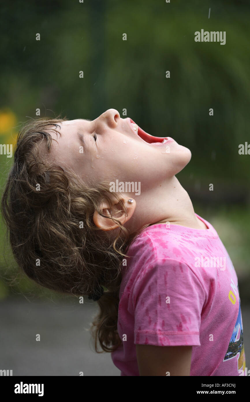 girl lets falling the raindrops in her mouth Stock Photo - Alamy