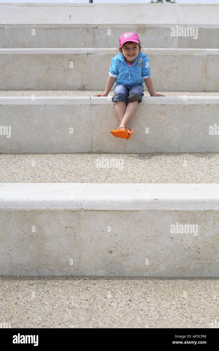 little girl sitting on big stairs Stock Photo - Alamy