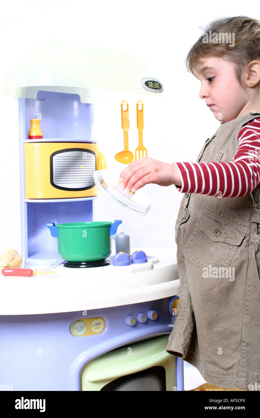 child playing at a childrens cooker Stock Photo - Alamy
