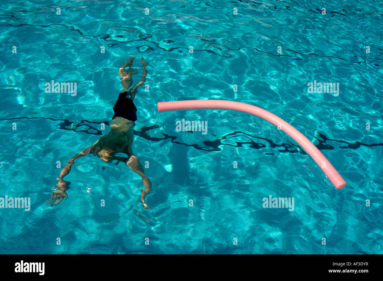 A young boy swinmming underwater in an open air pool in Wiveliscombe ...