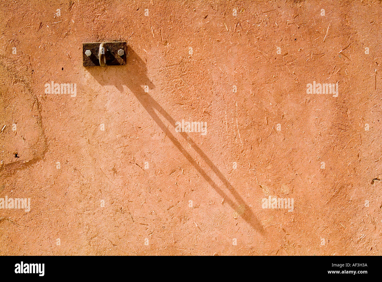 Traditional Marrakech pink ochre stone wall with brass bolt ring Stock ...