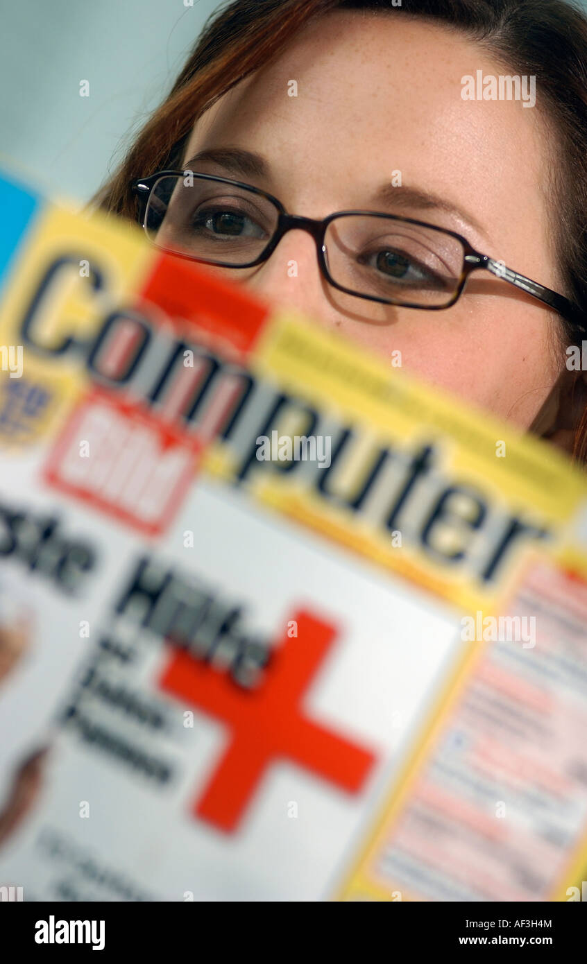 Woman reading computer magazine Stock Photo - Alamy