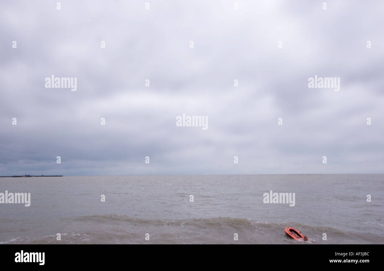 Lone man in small rubber dinghy frinton essex uk floating in the sea ...