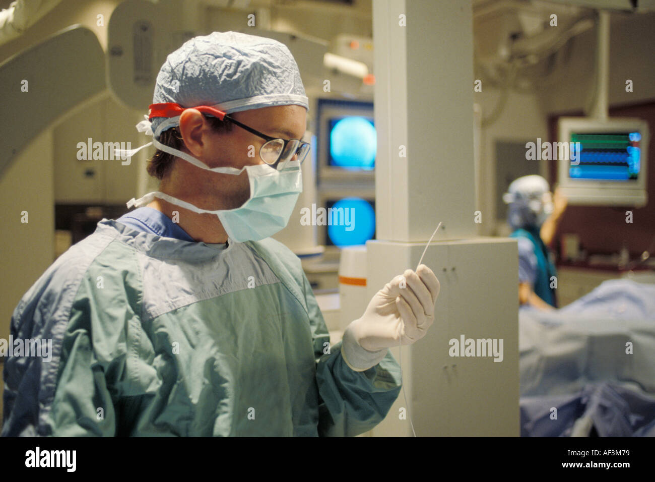 physician technician hospital catheter lab Stock Photo - Alamy