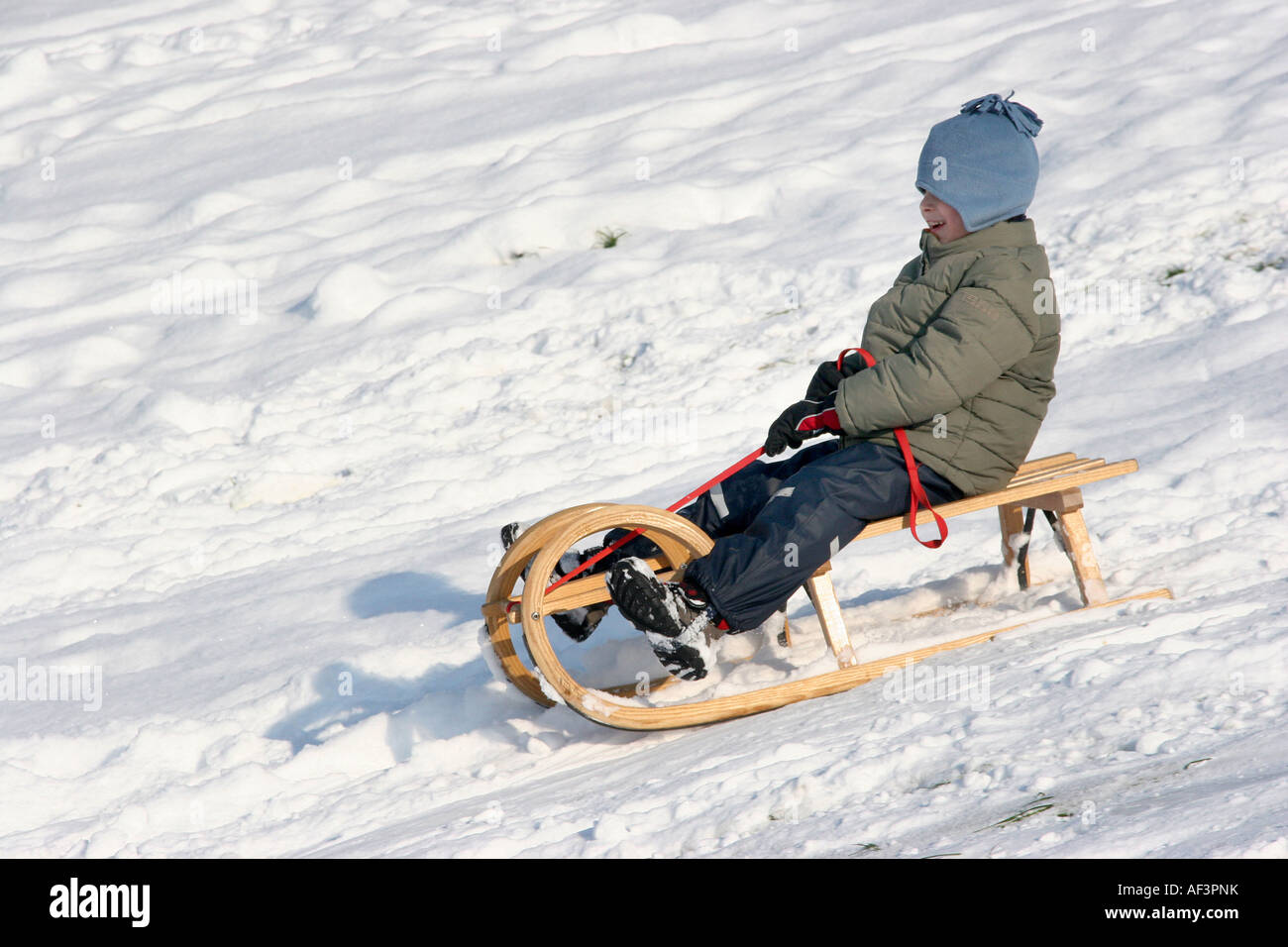 boy is sledging Stock Photo - Alamy