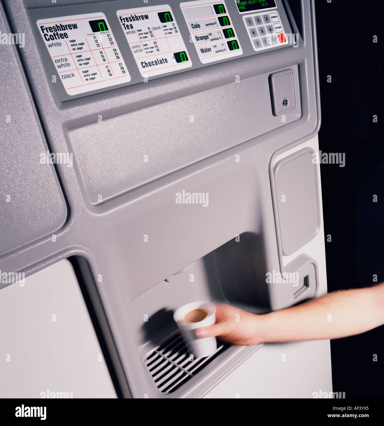 Hand taking drink from vending machine Stock Photo - Alamy
