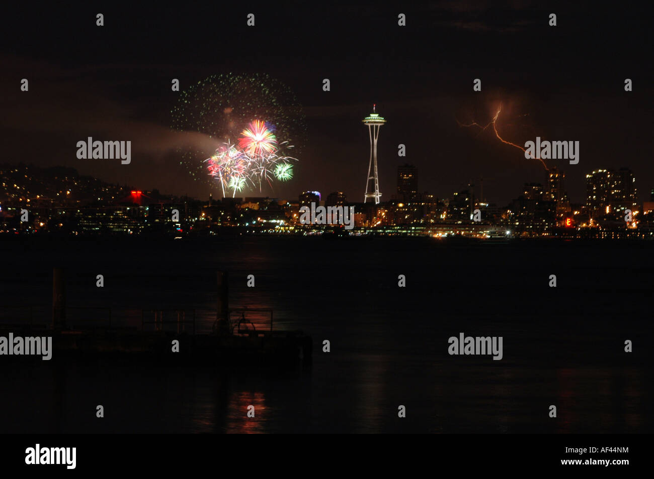 Fireworks, the Space Needle, and lightning over the Seattle skyline and ...