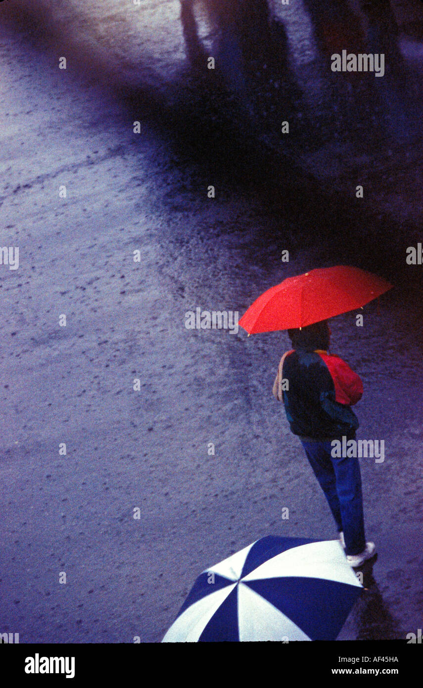 Person in the rain with a red umbrella Stock Photo - Alamy