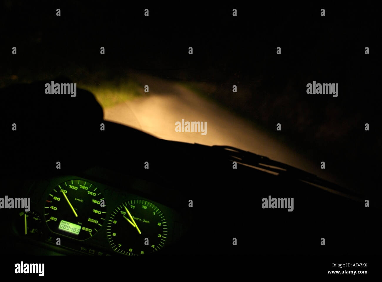 Drivers View from the Interior of a Car Driving at Night Along an ...