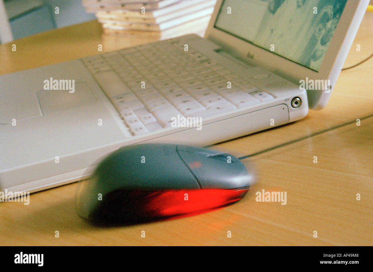 Optical mouse next to laptop Stock Photo - Alamy