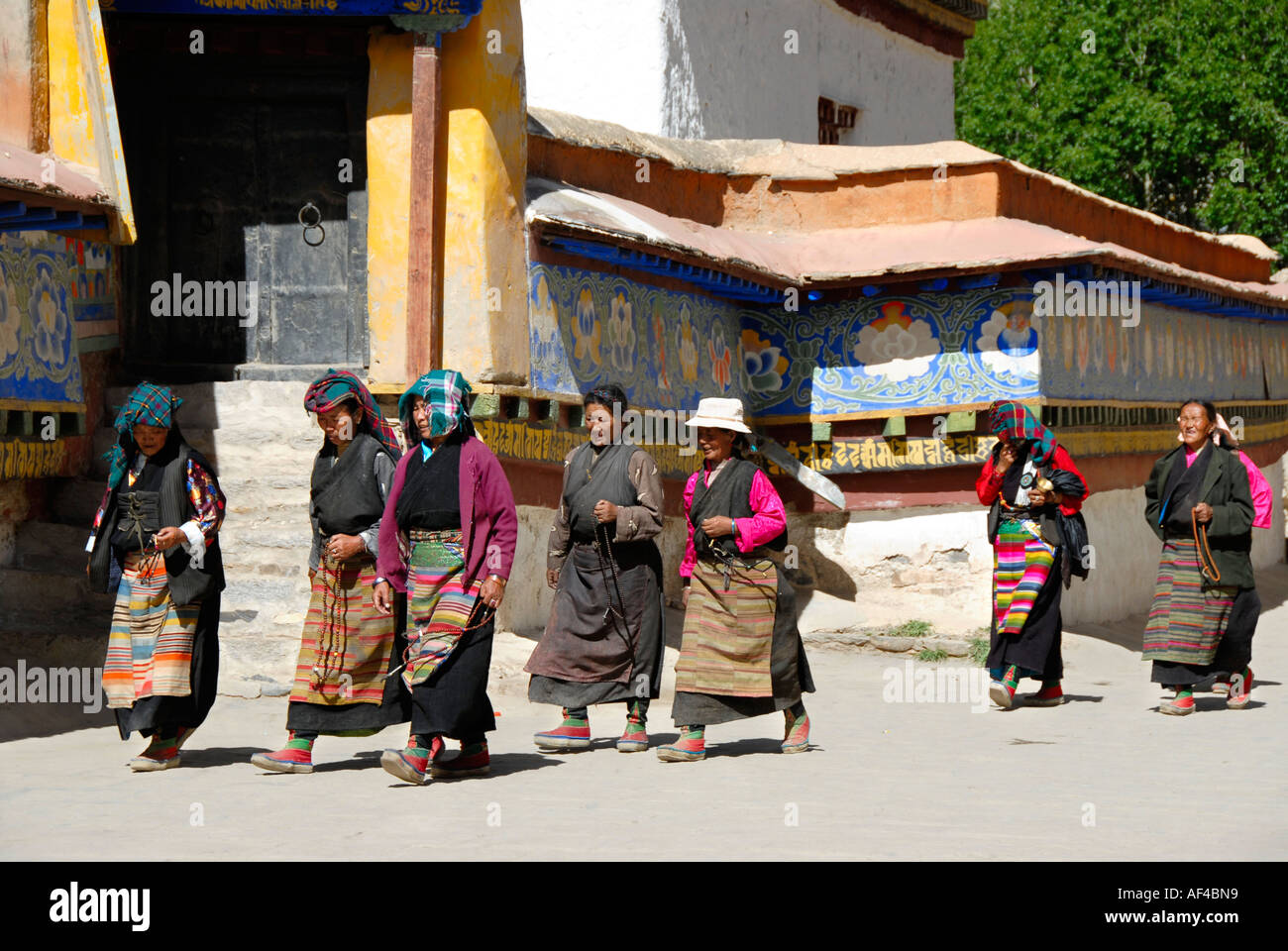 Tibetan pilgrims in traditional dress at kora around Kumbum Pelkor ...