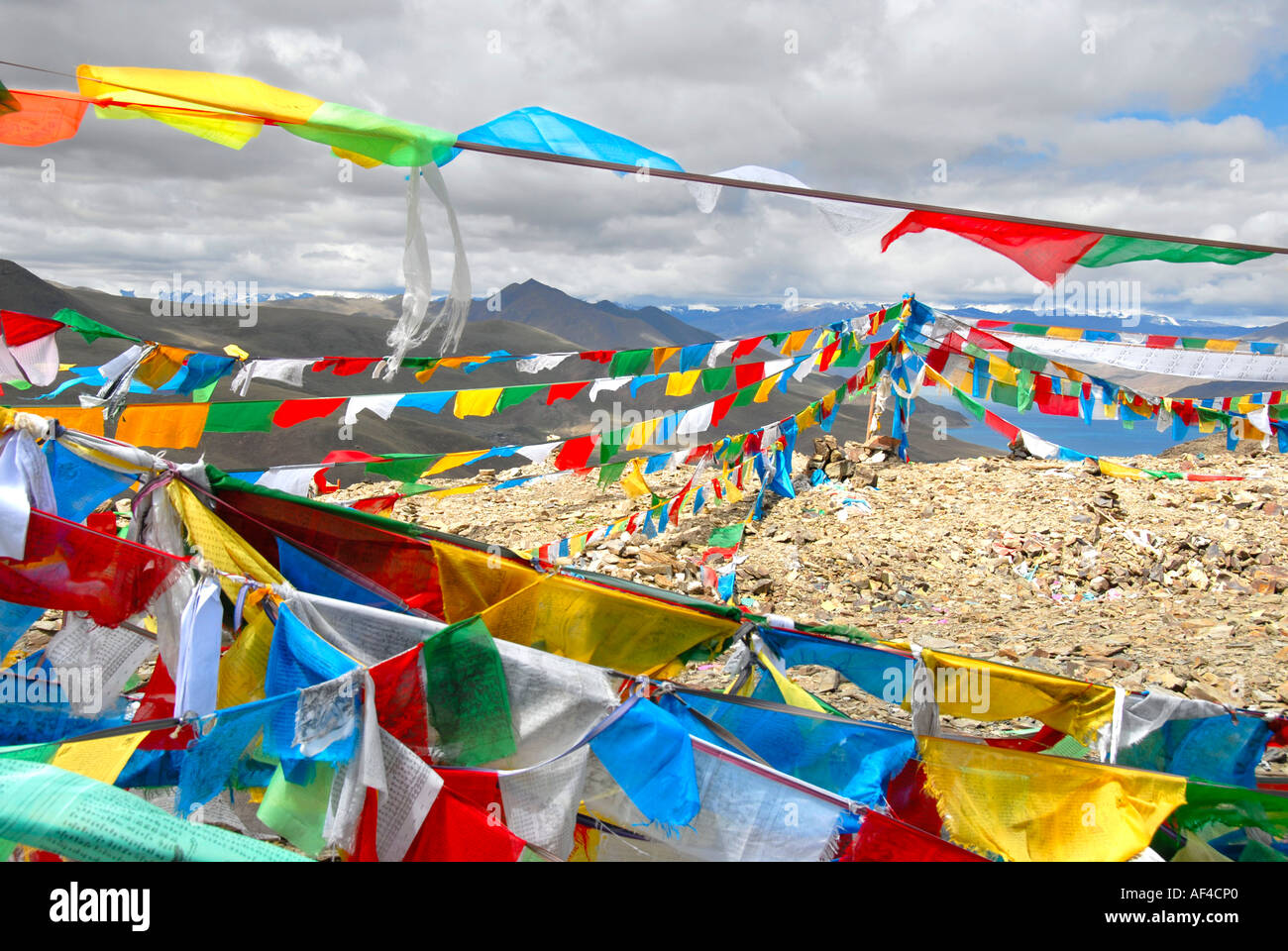 Colourful prayer flags wave in the wind at Kamba La Pass with view of ...