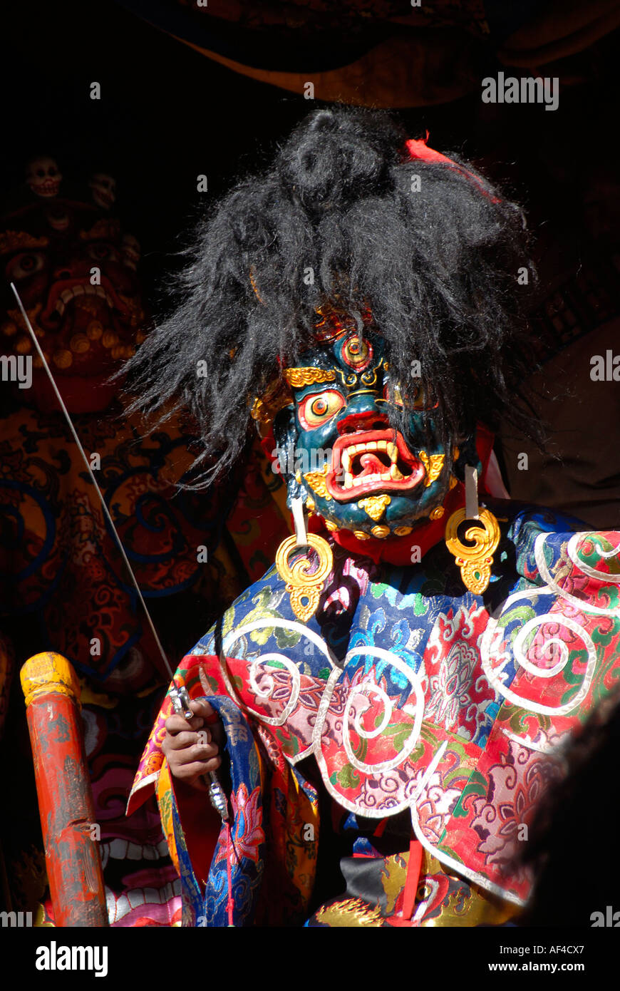 Monk wears fearful and blue mask of a demon at festival Rongbuk ...