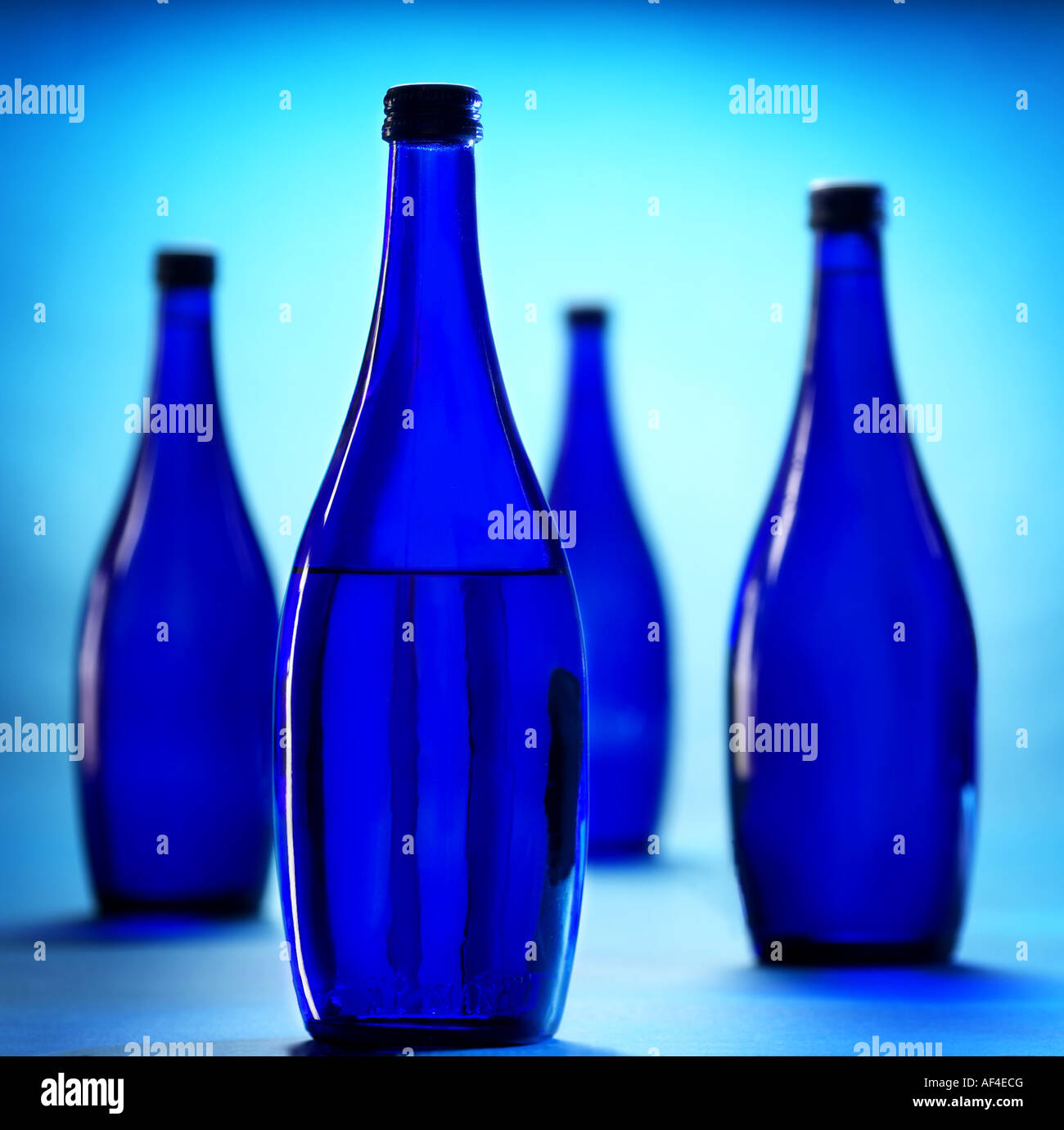 studio shot of four blue bottles arranged on a blue background Stock ...