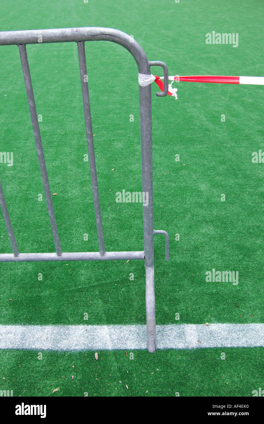fence and barrier tape in front of green artificial turf Stock Photo ...