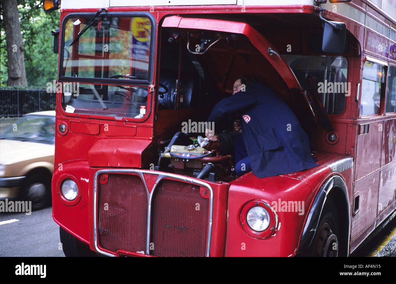 Mechanic fixing London bus engine after breakdown at Piccadilly London ...