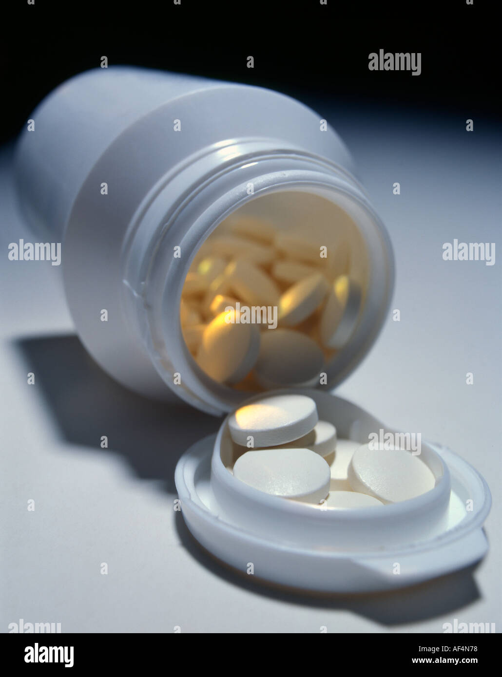 Open vial of medicine where pills are seen Stock Photo - Alamy