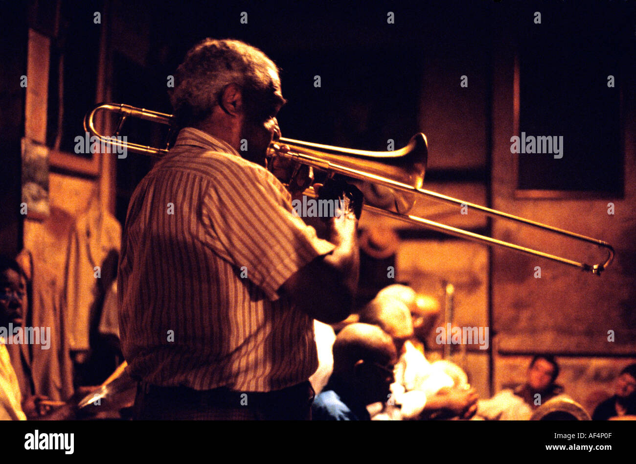 Trombone player playing with Bourbon Street jazz band under spotlights ...